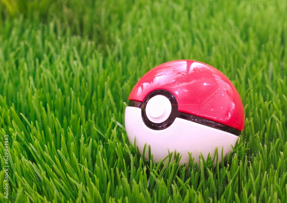 Japan, Tokyo - July 26, 2020 - Pokéball lying on green grass ...