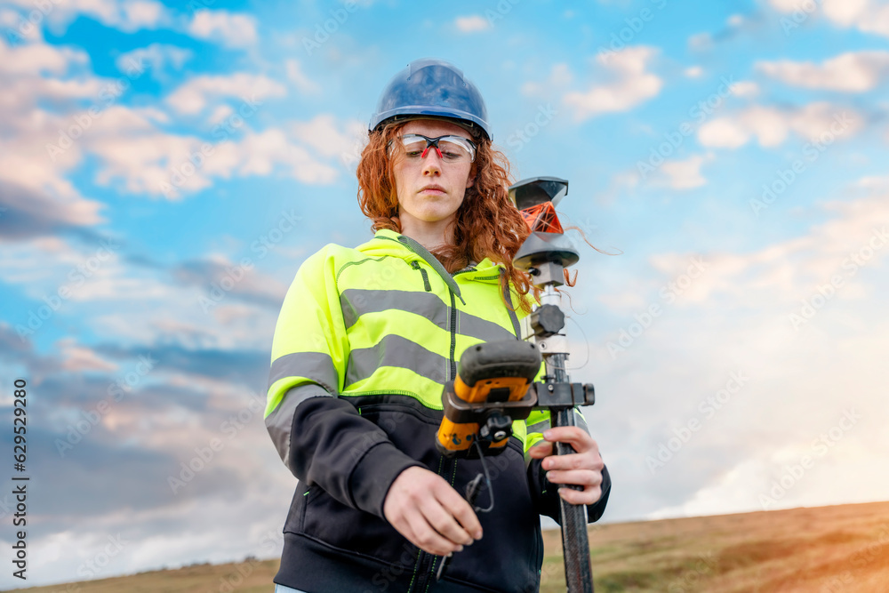 Female Woman land surveyor working with moder surveying geodesic ...