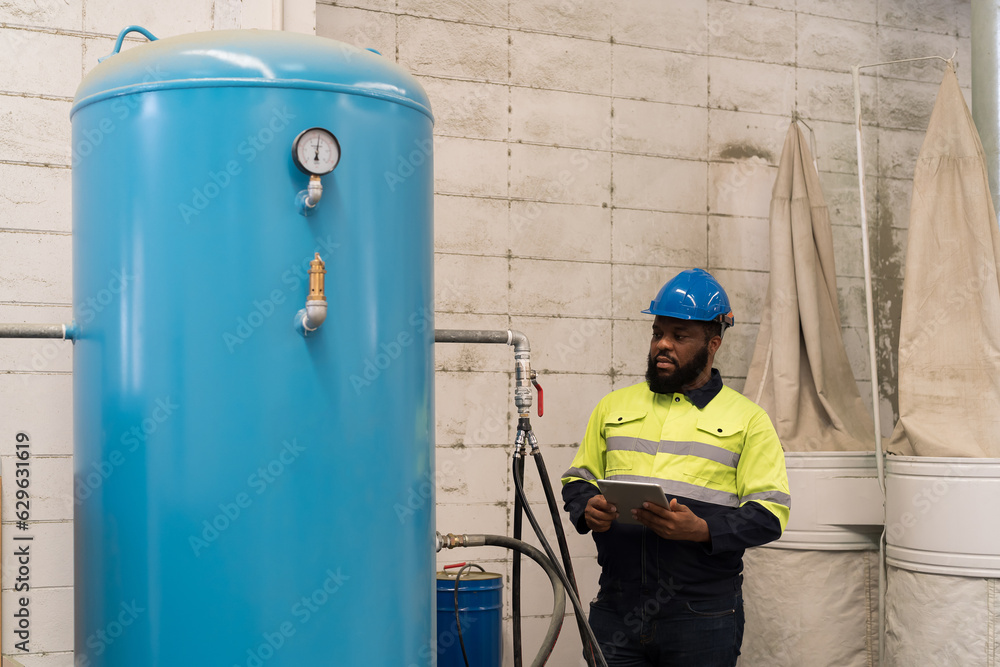 Factory male engineer worker working and using digital table checking ...