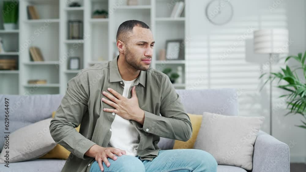 Adult male suffering from heartburn the handsome man is holding his ...