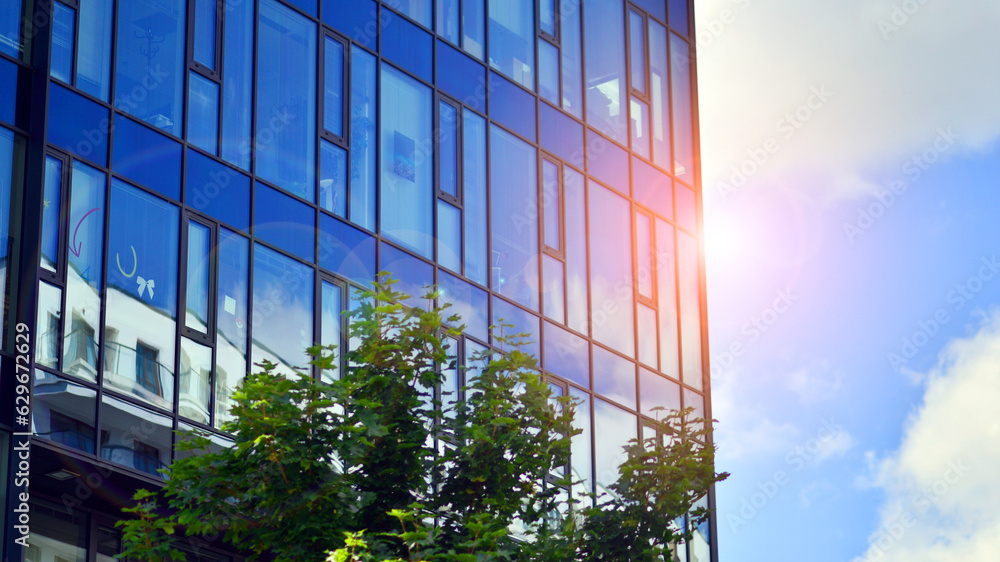 Reflection of modern commercial building on glass with sunlight. Eco ...