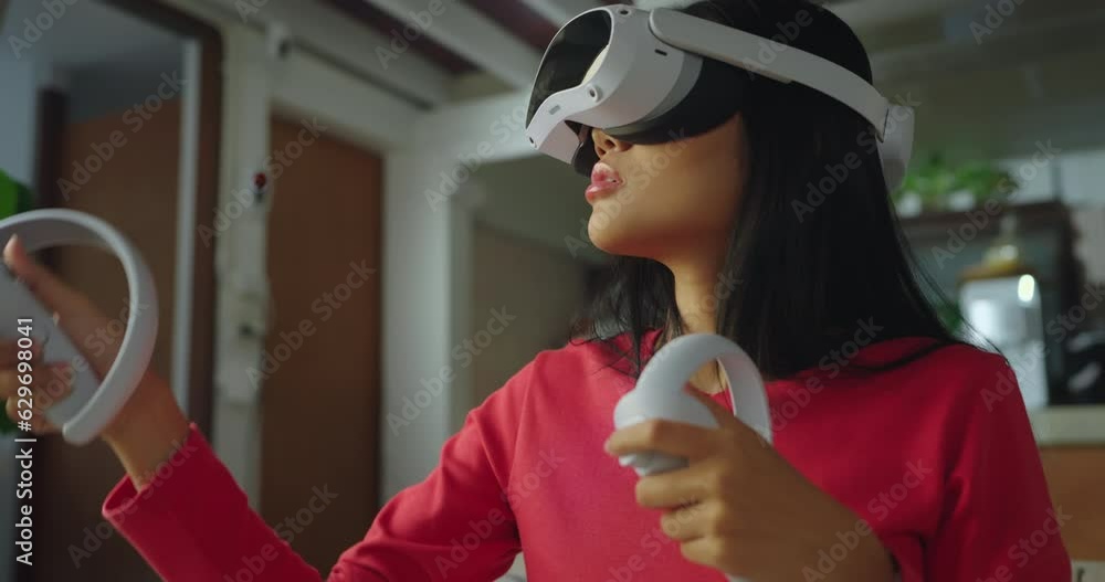 Beautiful asian woman relaxing and playing VR goggles and using ...