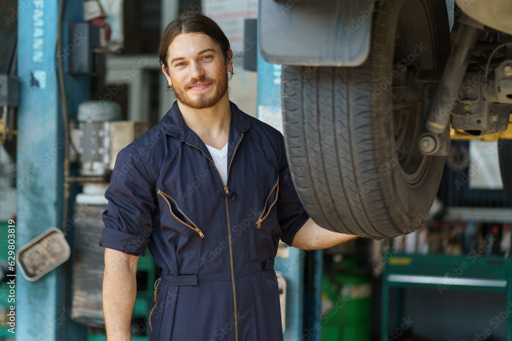 mechanic worker checking car replacing car wheel and tyre in auto ...