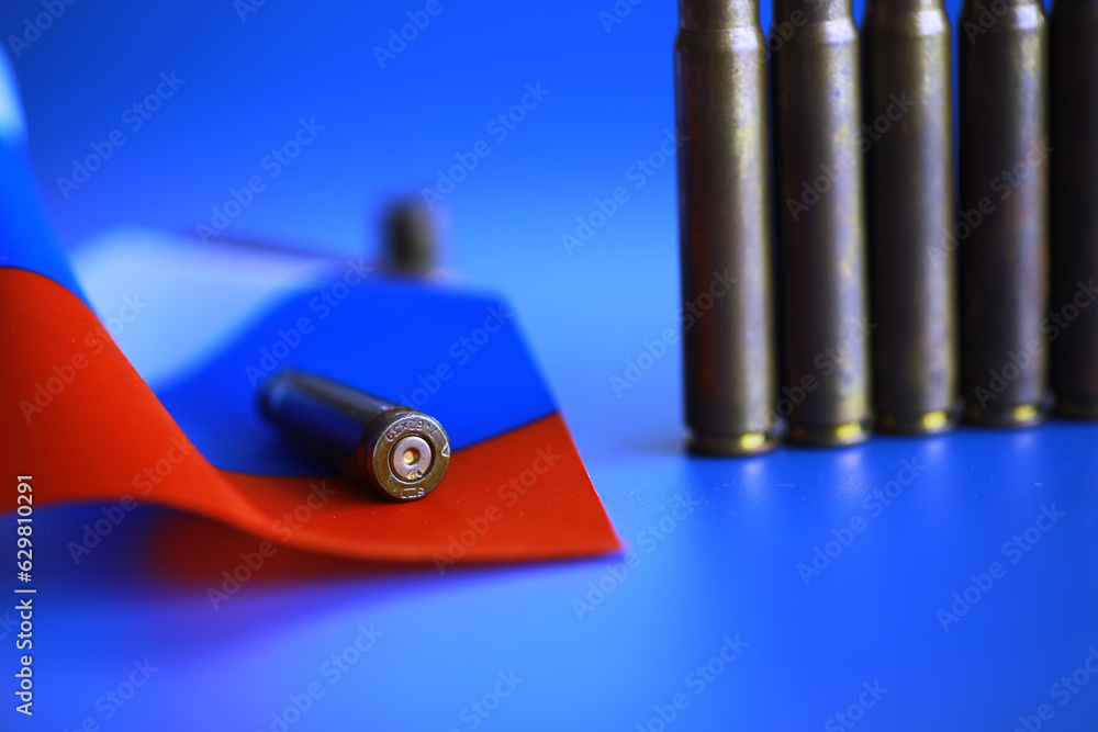 Russian flag and bullet casings on the table. Background concept ...