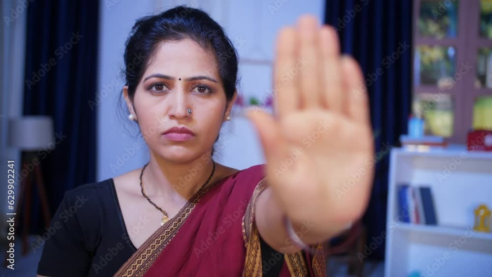A female victim of domestic violence showing the stop abusing hand sign ...