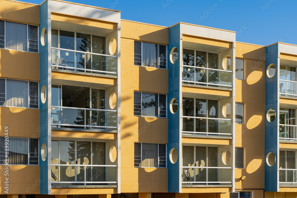 Modern building facade with circular cut outs and unusual shadow ...