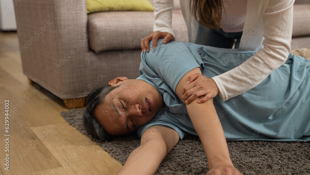 Closeup of unconscious Asian senior male grandfather lying on floor ...