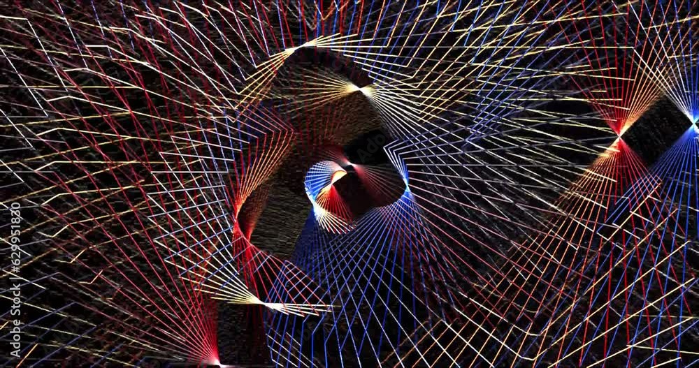 Multi-colored beams of light of red, white and blue shades are ...