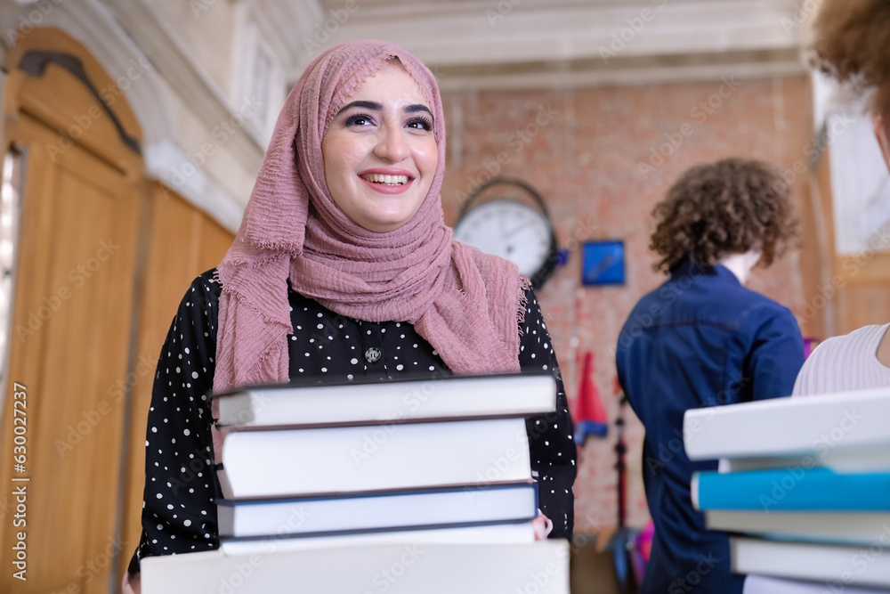 Beautiful International Emirati Student at library with books in the ...