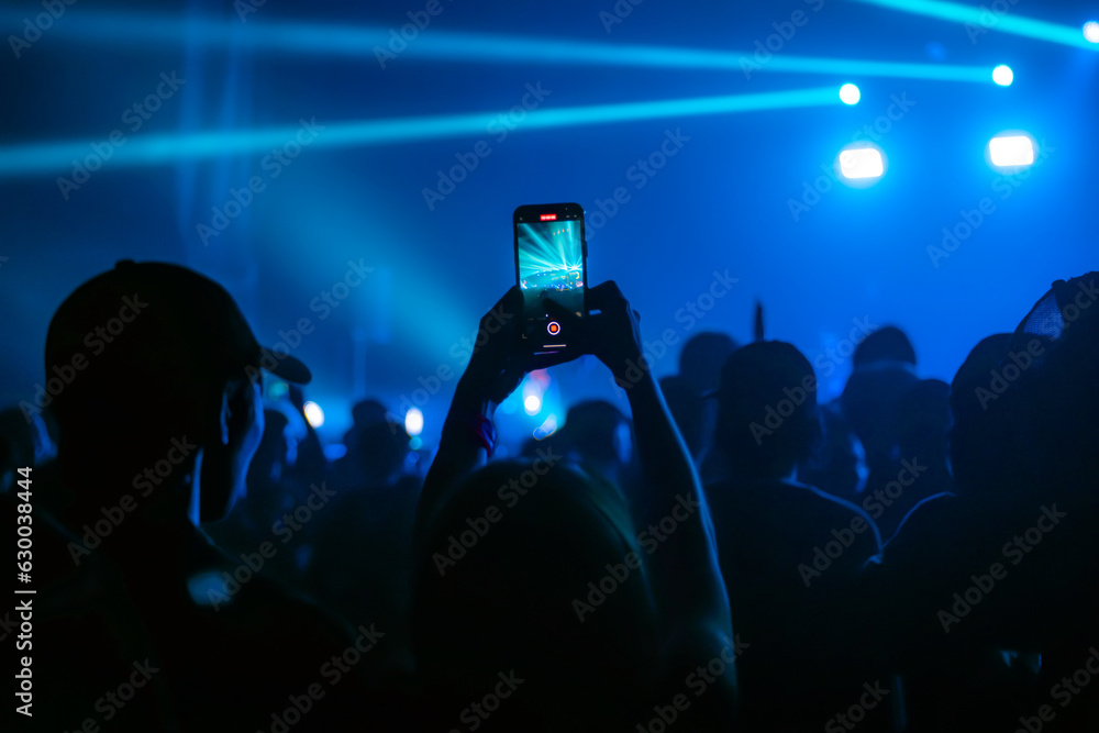 People holding smart phone and recording and photographing in concert ...