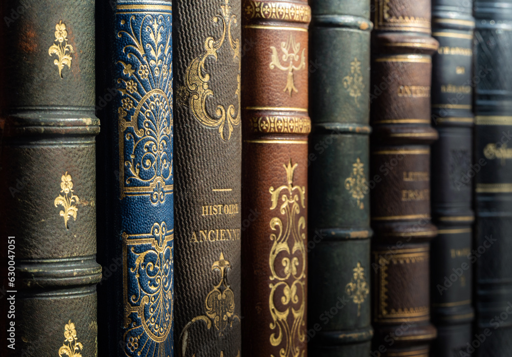Old books close-up. Title of the book is printed on the spine. Tiled ...