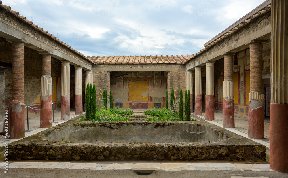 View of outdoor patio lined with columns in the historic city of Pompei ...