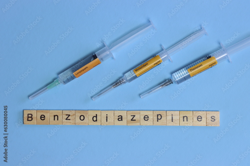Benzodiazepines in tree syringe in a light blue background. Midazolam ...