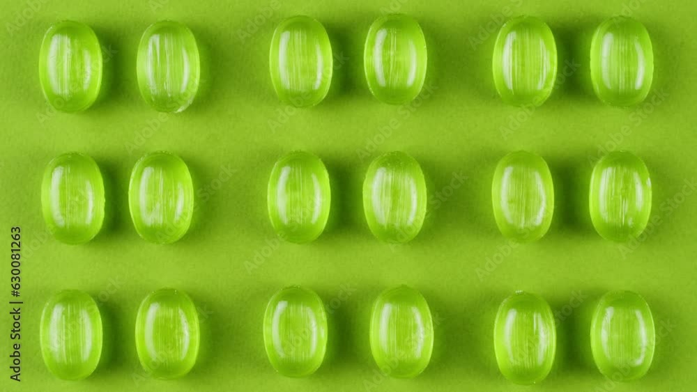 Green mint mentol lollipops, candies, bonbons disappear on purple ...