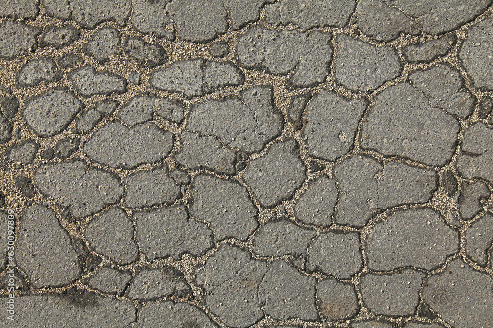 Asphalt surface of the road with a cracks in the middle, background ...