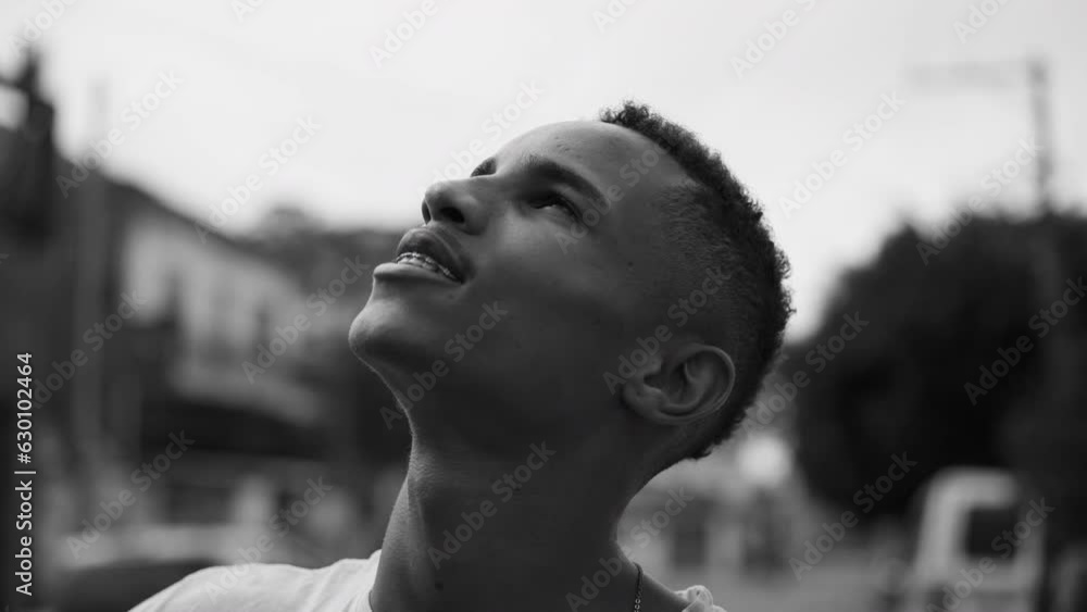 One faithful African American man looking up at sky with HOPE. Smiling ...