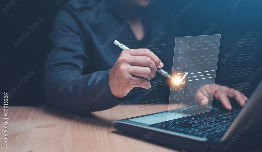 Checklist concept, Businessman using laptop computer and checking mark ...