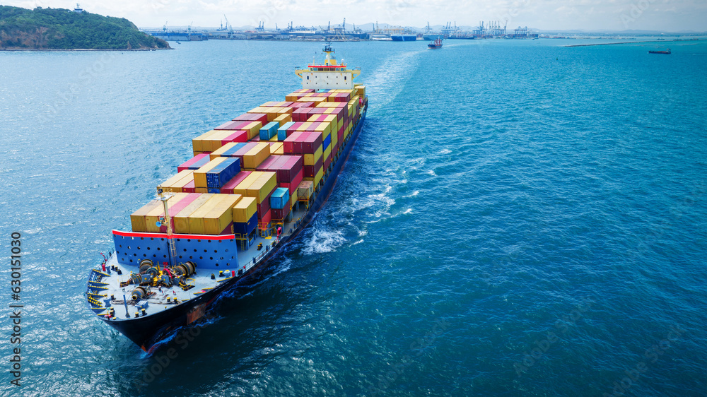 Aerial side view of cargo container ship carrying container from custom ...