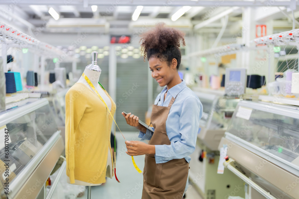 american female designer Garment design with mannequin with tape ...