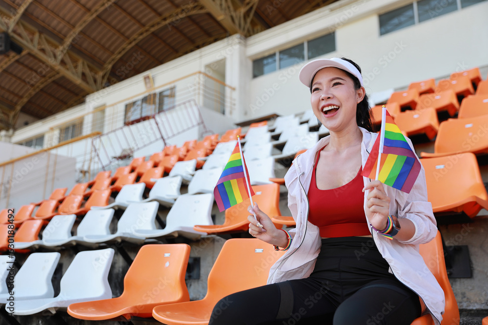 Happy and excited young female asian transgender LGBT sport fan ...