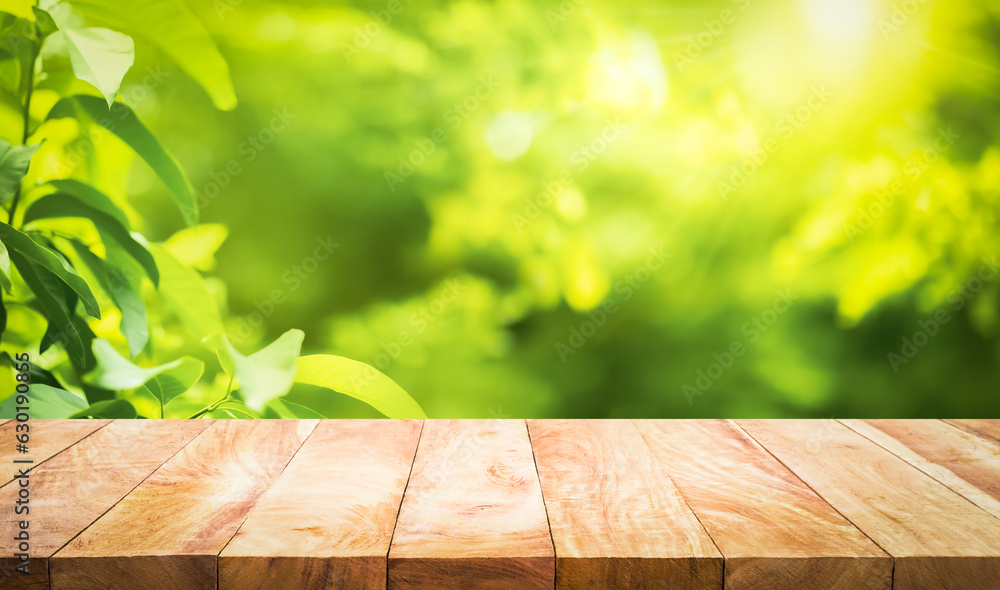 selective focus.real wood table top texture on blur leaf tree garden ...
