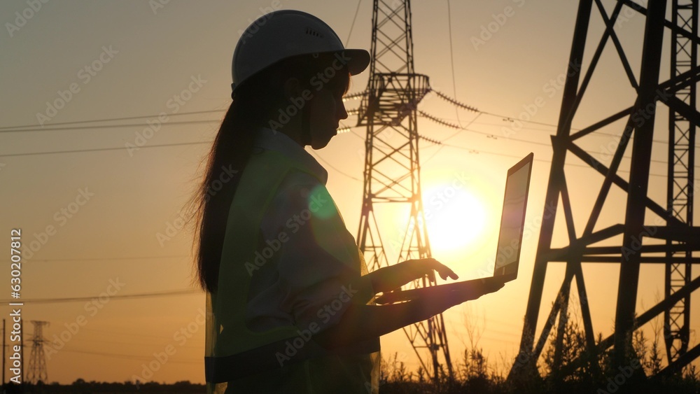 silhouette electrical engineer, work laptop sunset, electric tower ...