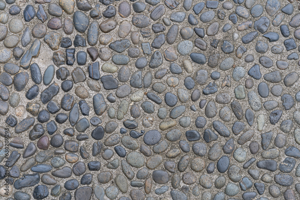 Pebble stone concrete walkway texture, dark tone round stones surface ...