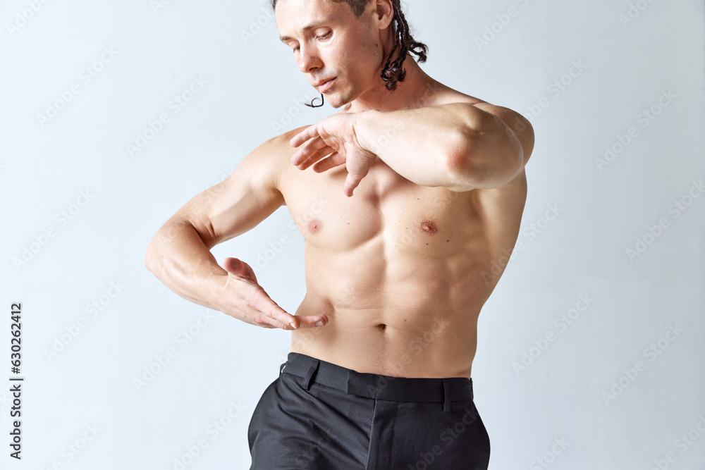 Handsome mature man posing shirtless against grey studio background ...