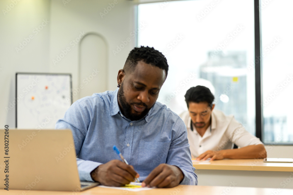 Young black african man relaxing using laptop computer working and ...