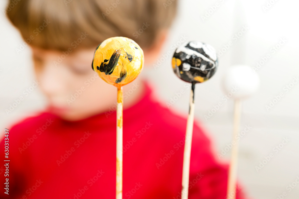 Boy painting styrofoam balls when making model of Solar System for ... Boy painting styrofoam balls when making model of Solar System for ...