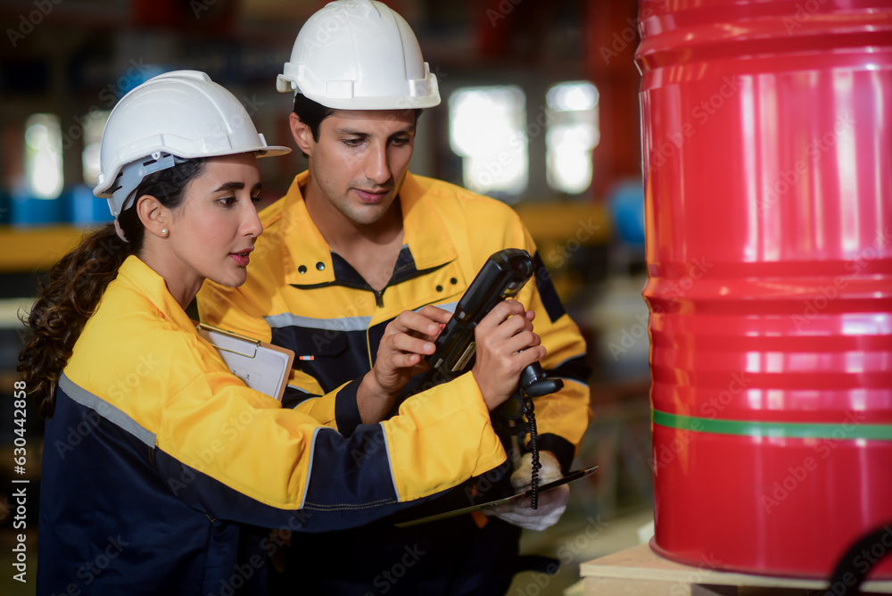 2 Latino male and female auditor wearing safety uniform workwear with ...