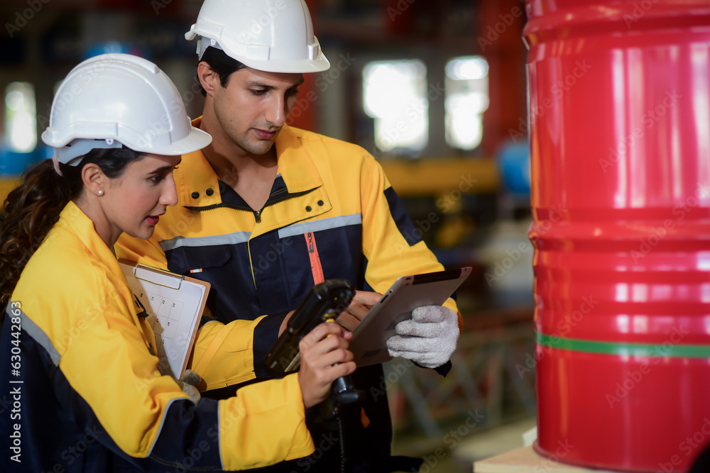 2 Latino male and female auditor wearing safety uniform workwear with ...