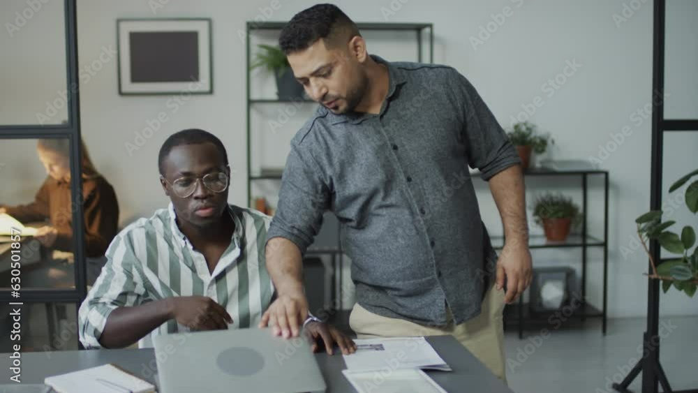 Impudent Middle Eastern man disturbing his African American subordinate ...