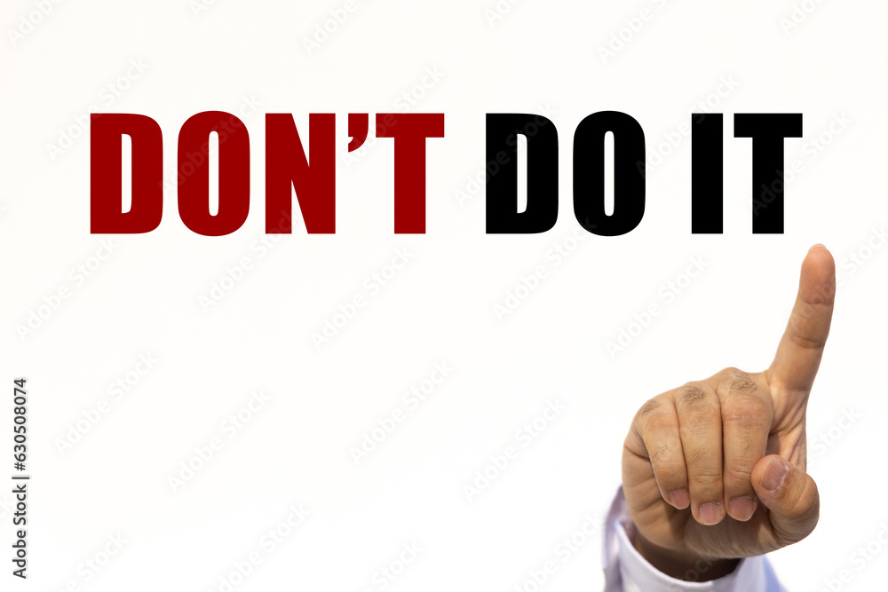 Don't do it text on white wall background with businessman's finger ...