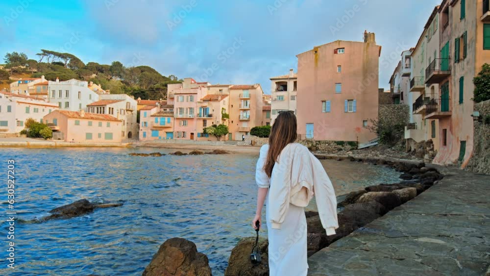 Beautiful girl enjoys the sunset in Cote d'Azur, a coastal town on the ...