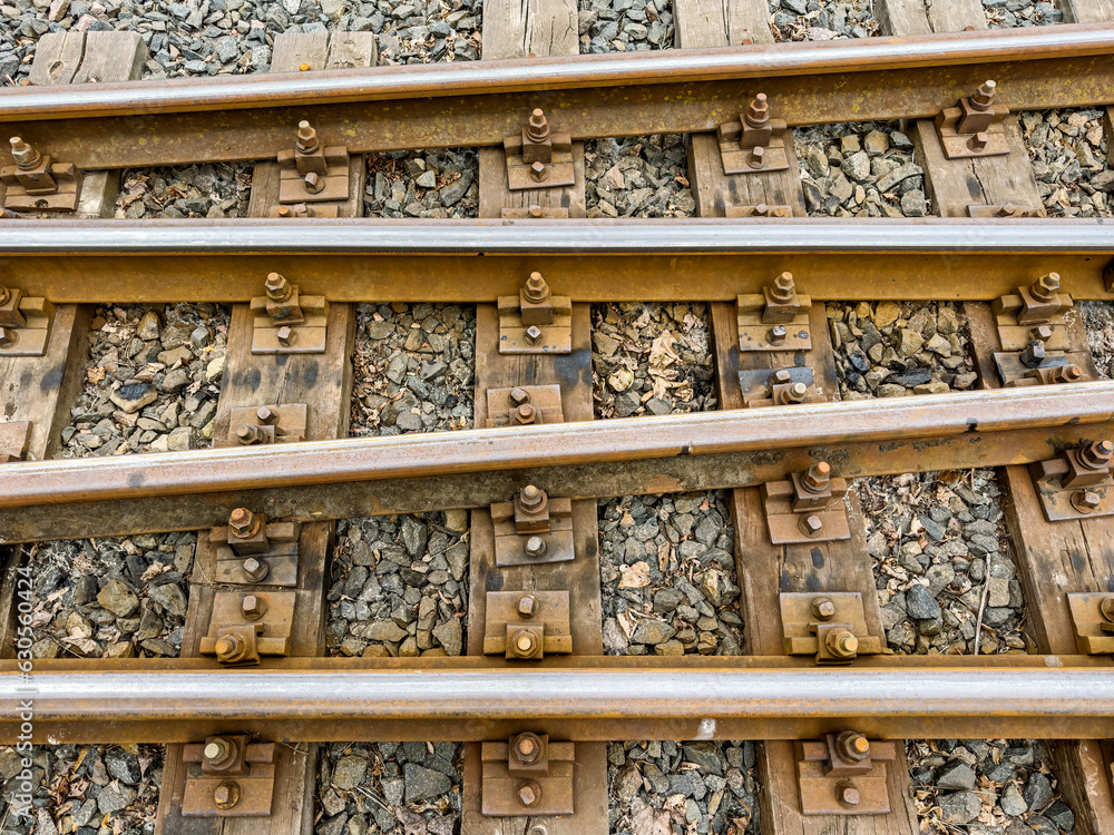 narrow gauge railway with thresholds, gravel and rusty bolts ...