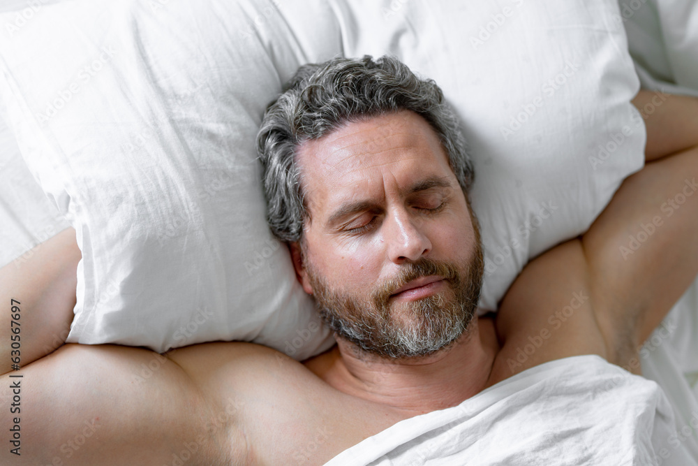 Male sleeps on pillow. Gray hair man sleep in white bed. Senior man ...