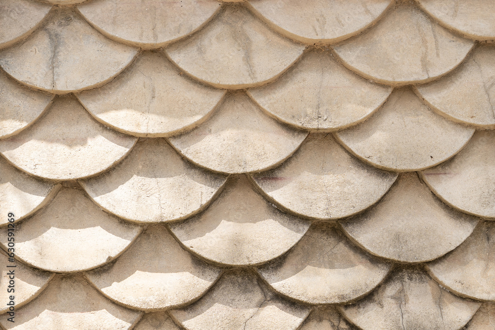 Up-close wall designed to resemble fish scales, gleaming under vibrant ...