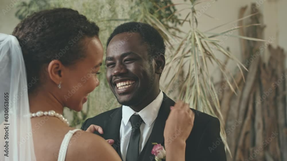 Video Stock Back view chest up of young Biracial bride adjusting black ...