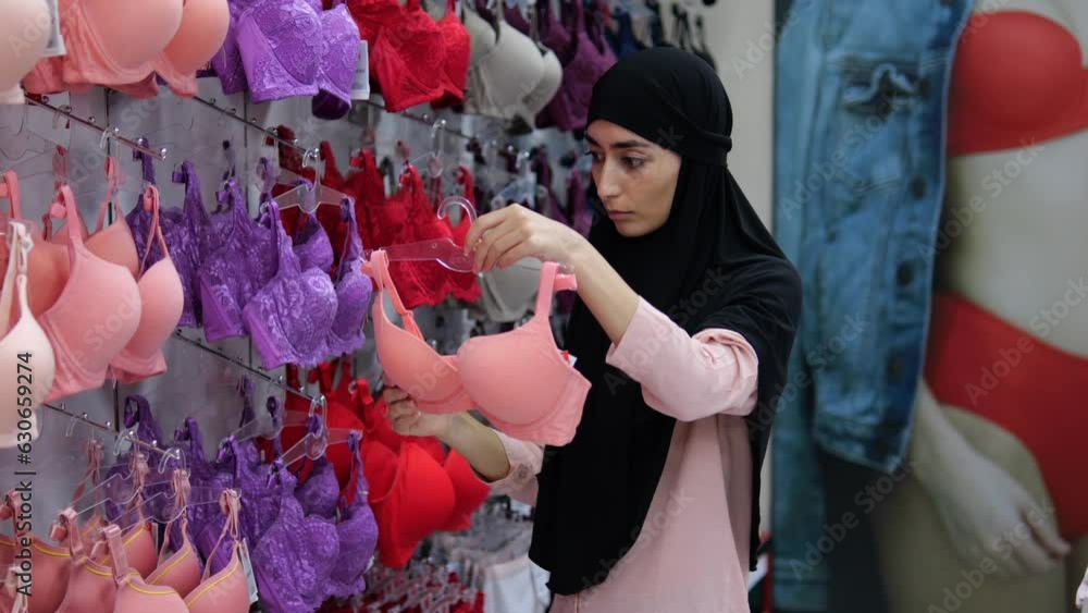 Muslim woman customer, female client in lingerie store chooses pink ...