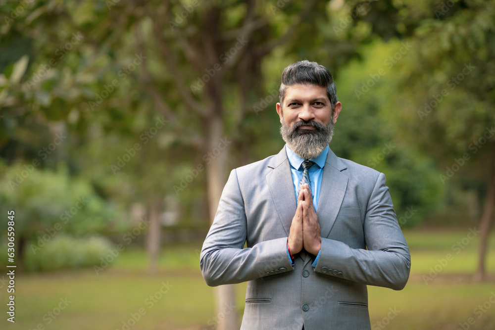 Indian businessman giving namaste or welcome gesture at park. Stock ...