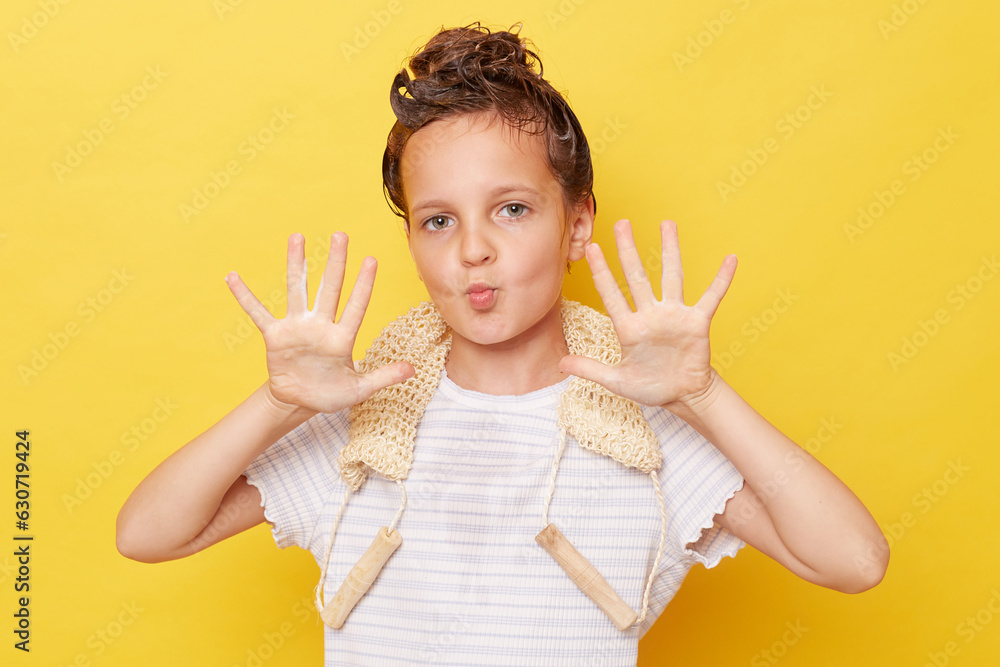 Funny little girl with wet hair wearing casual white T-shirt standing ...