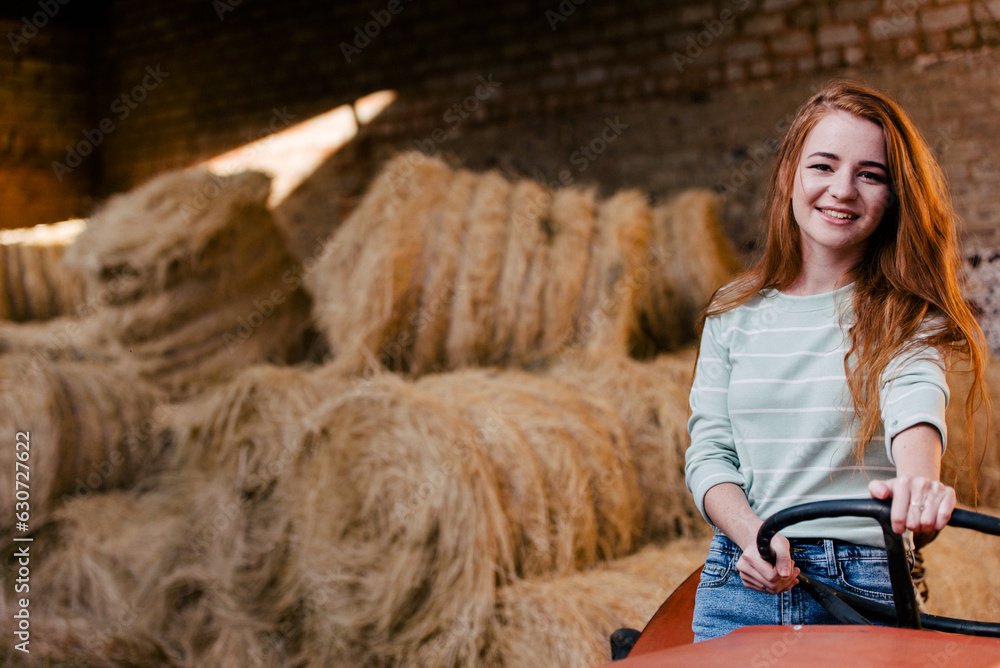 Farm girl farmer lady hay tractor farm work red hair Demin skirt shed ...