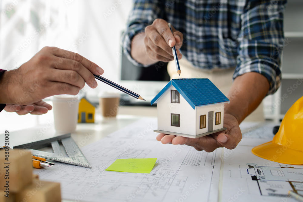 The home design architects are reviewing the house plan draft, the ...