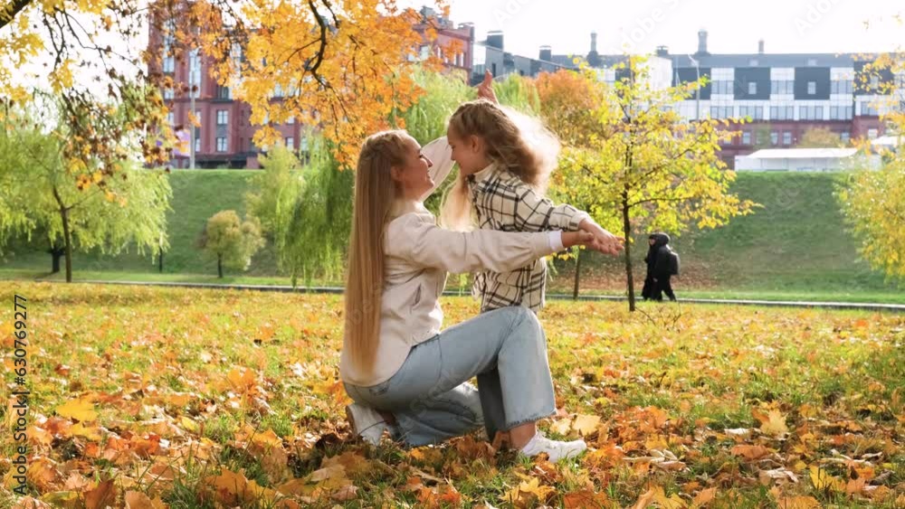 Mother And Daughter Spend Time Together In The Autumn Park Mother