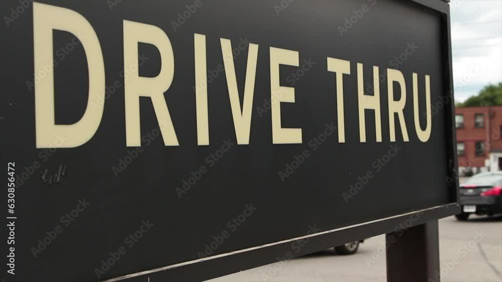 drive thru sign in white capital letters on black background with black ...