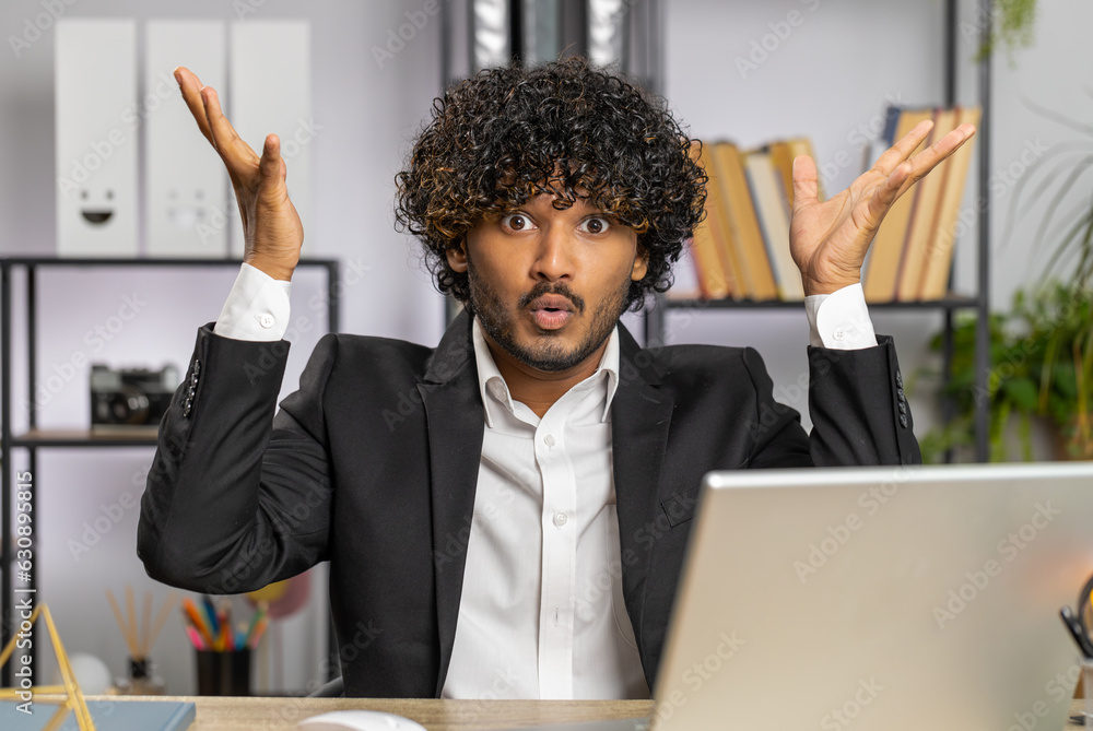 Excited amazed indian bearded businessman freelancer looking shocked ...