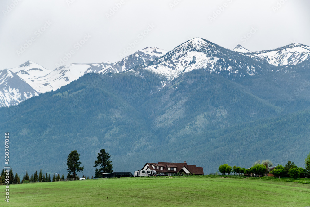 Rural Farm House in front of Wallowa Mountains on Green Rolling Hills ...