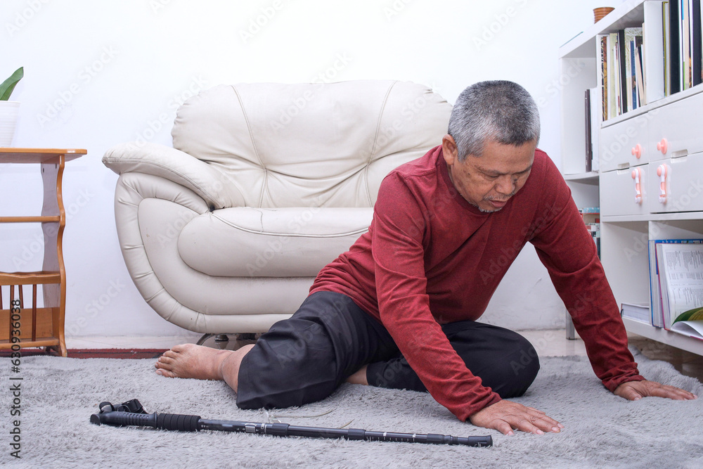 Senior Asian man falling down and lying on floor with wooden walking ...