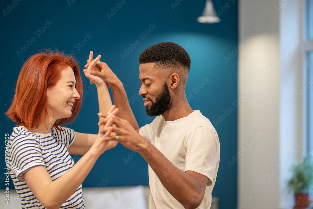 Happy loving young diverse couple dancing romantic dance in modern ...